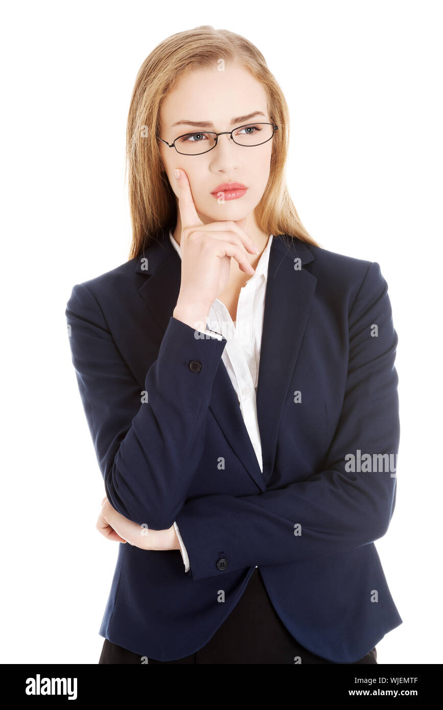 Beautiful business woman with her finger on cheek thinking. Isolated on ...