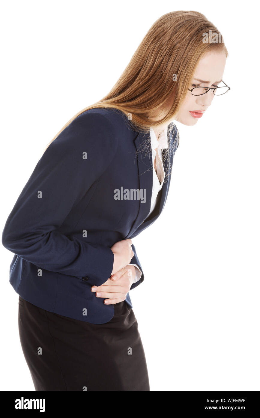 Beautiful business woman is touching her stomach. Isolated on white ...