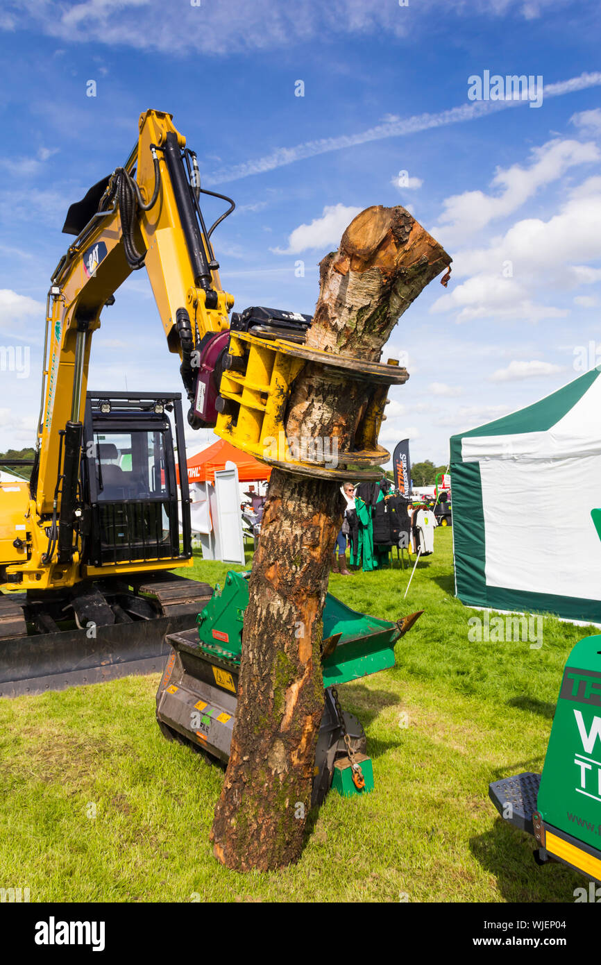 Caterpillar digger with tree and log handling attachment on display at ...