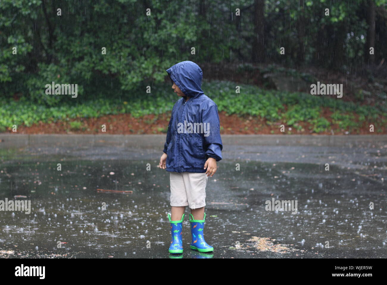 Boy in the rain hi-res stock photography and images - Alamy