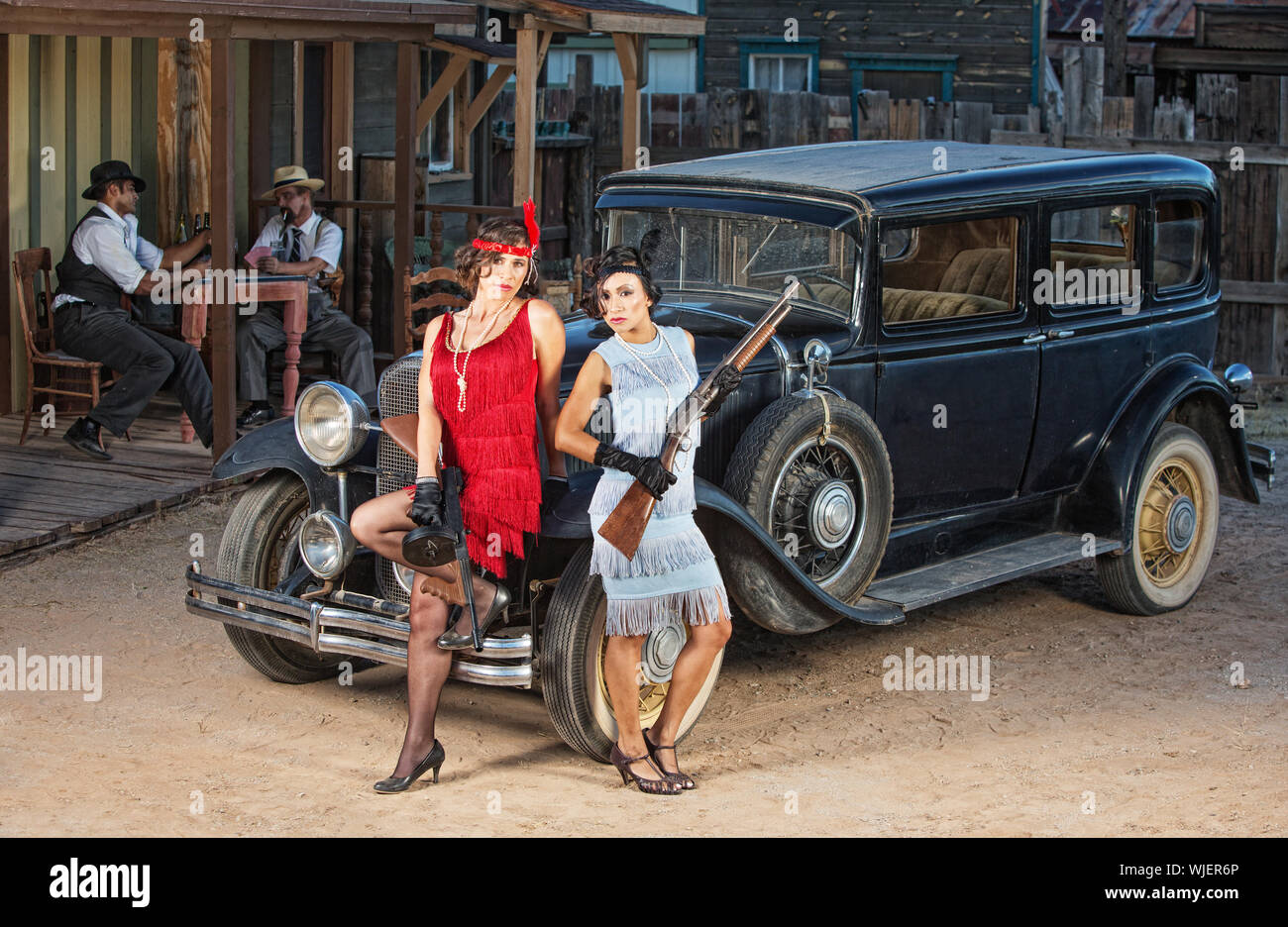 Group of 1920s gangsters near old car with guns Stock Photo - Alamy
