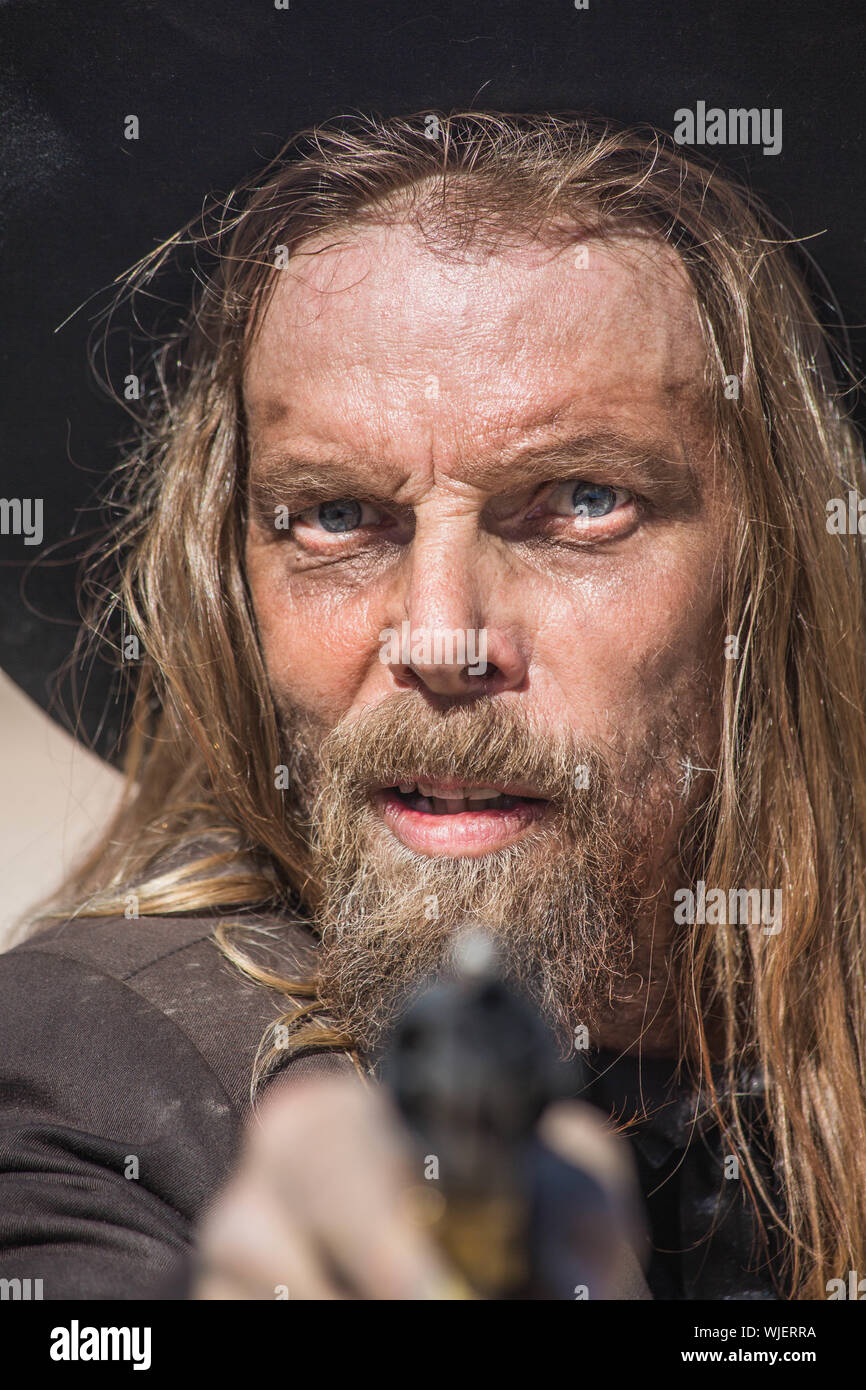Stern Cowboy Points a Gun at You Stock Photo - Alamy