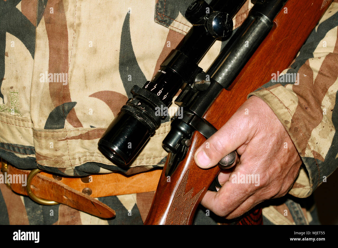 A hunter holding his riffle Stock Photo - Alamy