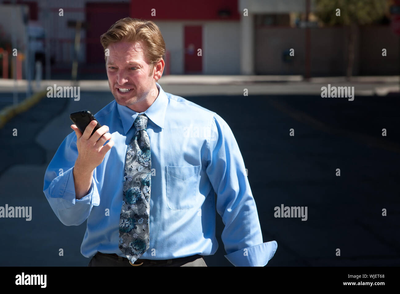 Frustrated man tries desperately to make a phone call Stock Photo - Alamy