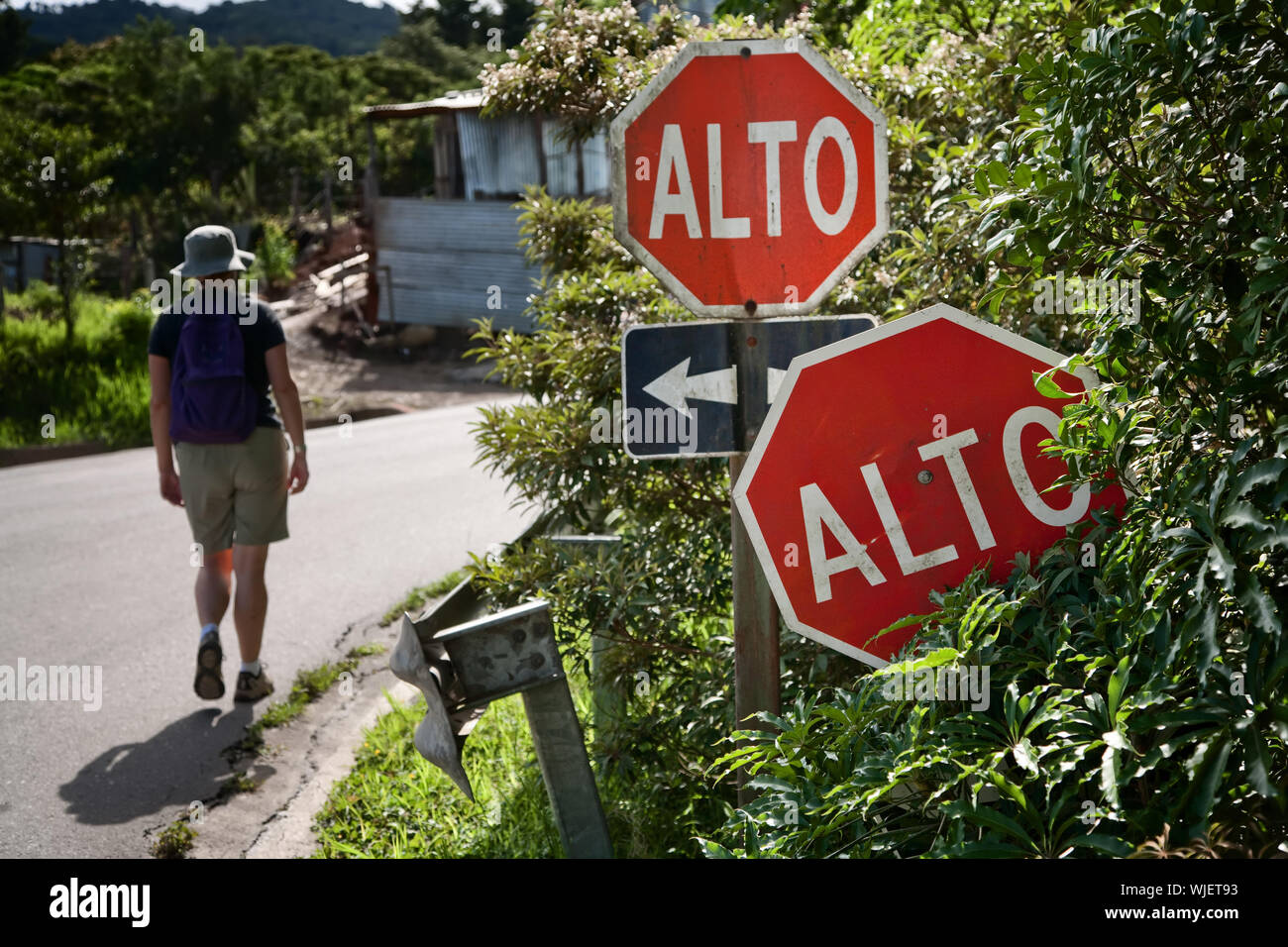 Hiker near alto signs at intersection in Santa Elena Costa Rica Stock ...