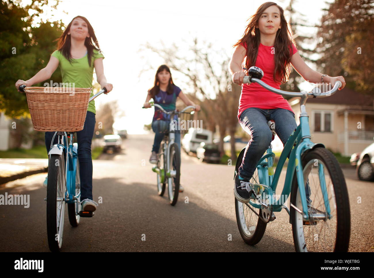 Group of teenage girls cycling along the street together Stock Photo ...