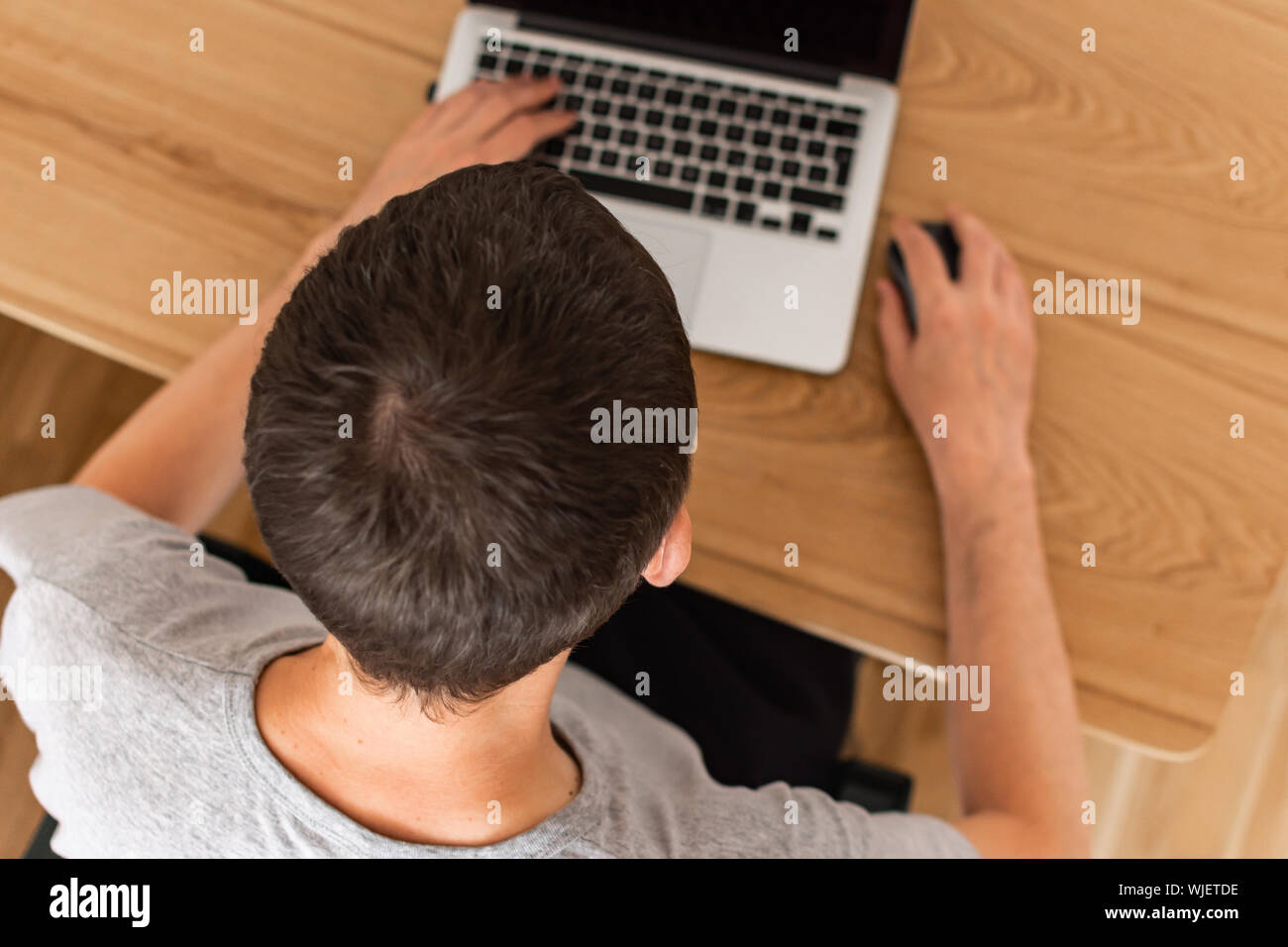 Top view of a man working on a laptop at home Stock Photo - Alamy