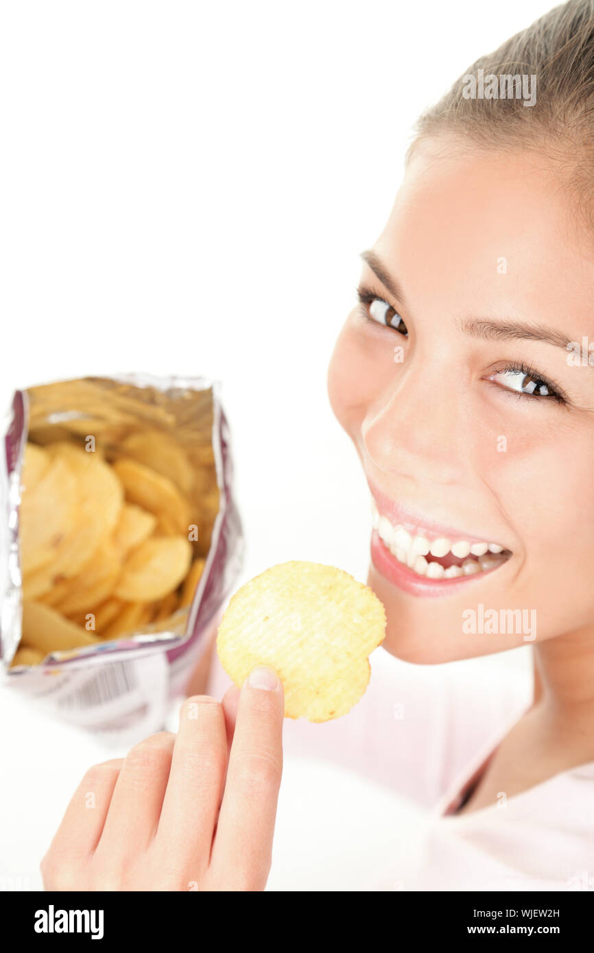Woman eating chips Stock Photo - Alamy