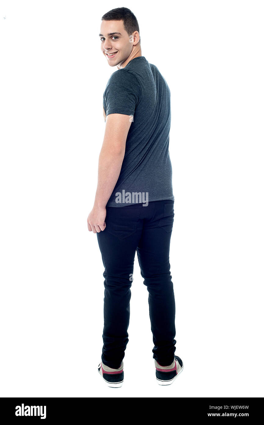 Full length image of smart young man turning back Stock Photo - Alamy