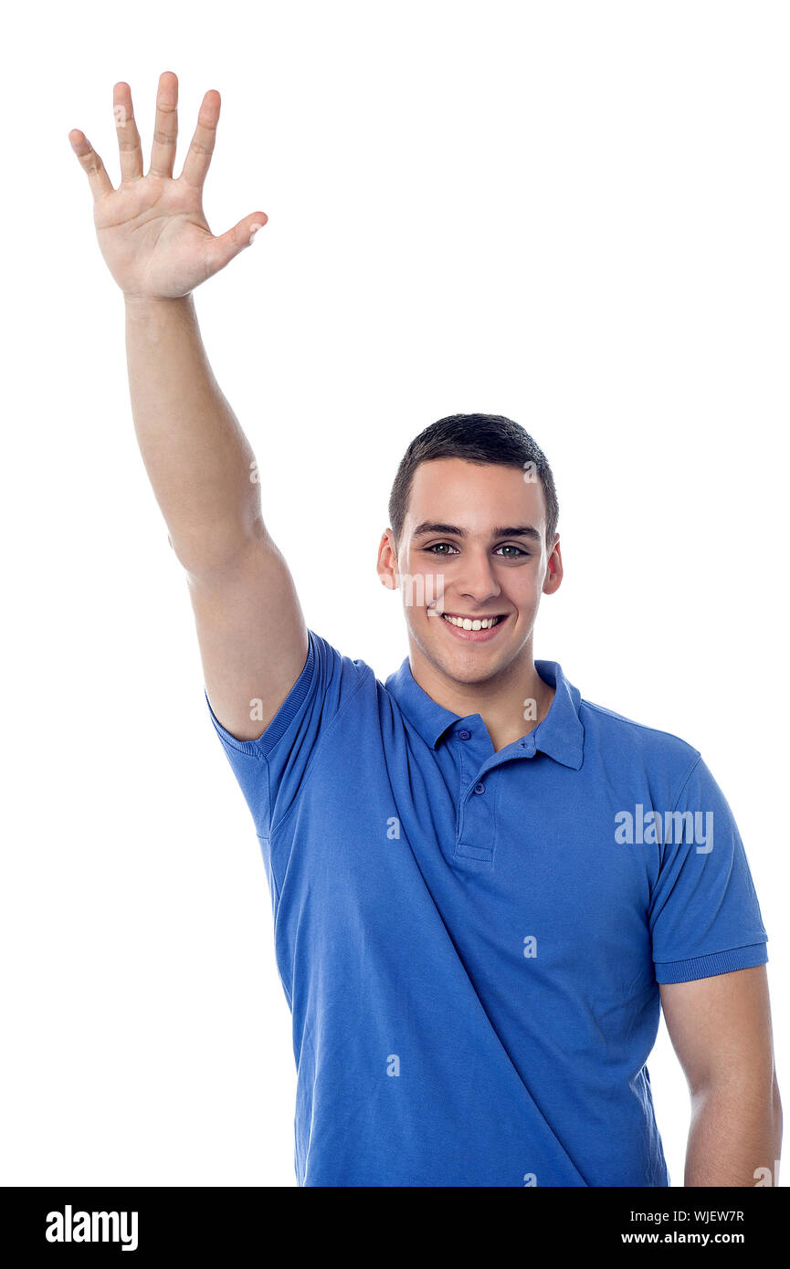Handsome young man waving to his friends Stock Photo - Alamy