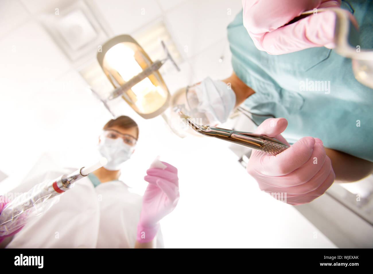 Dentist pulling tooth hi-res stock photography and images - Alamy