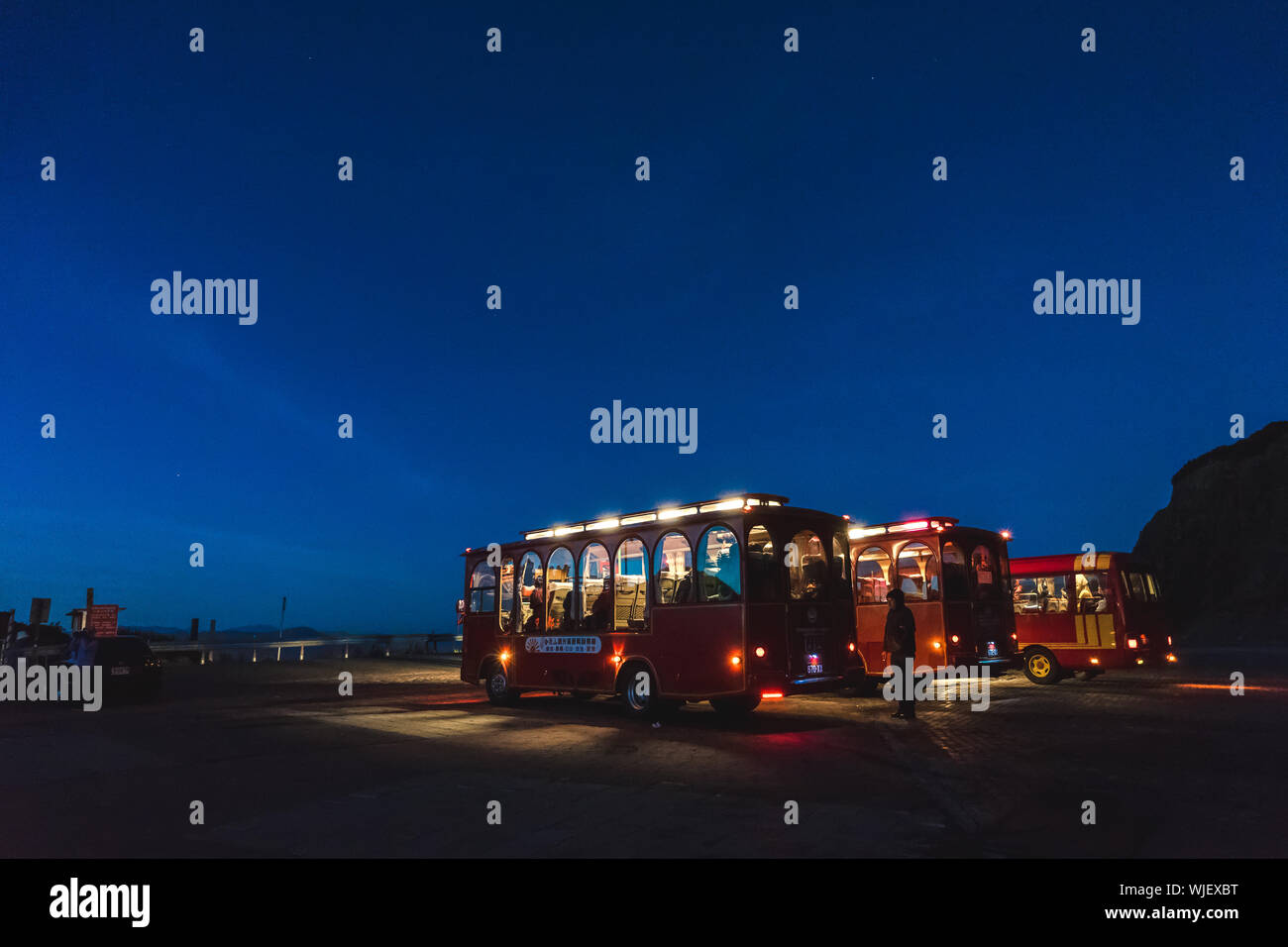 Illuminated Buses At Night Stock Photo - Alamy