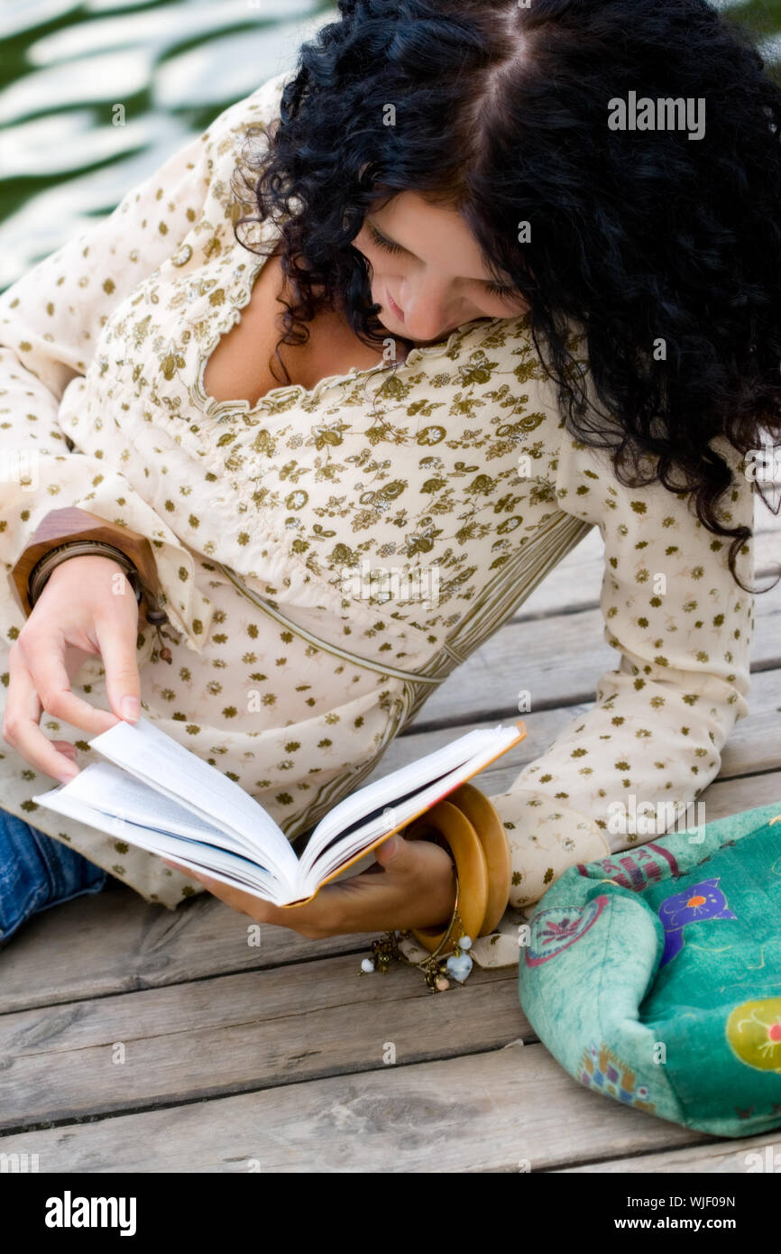 outdoor portrait of a beautiful woman reading a book Stock Photo - Alamy