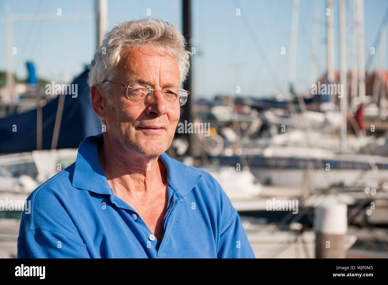 Portrait of an elderly man in harbor Stock Photo - Alamy