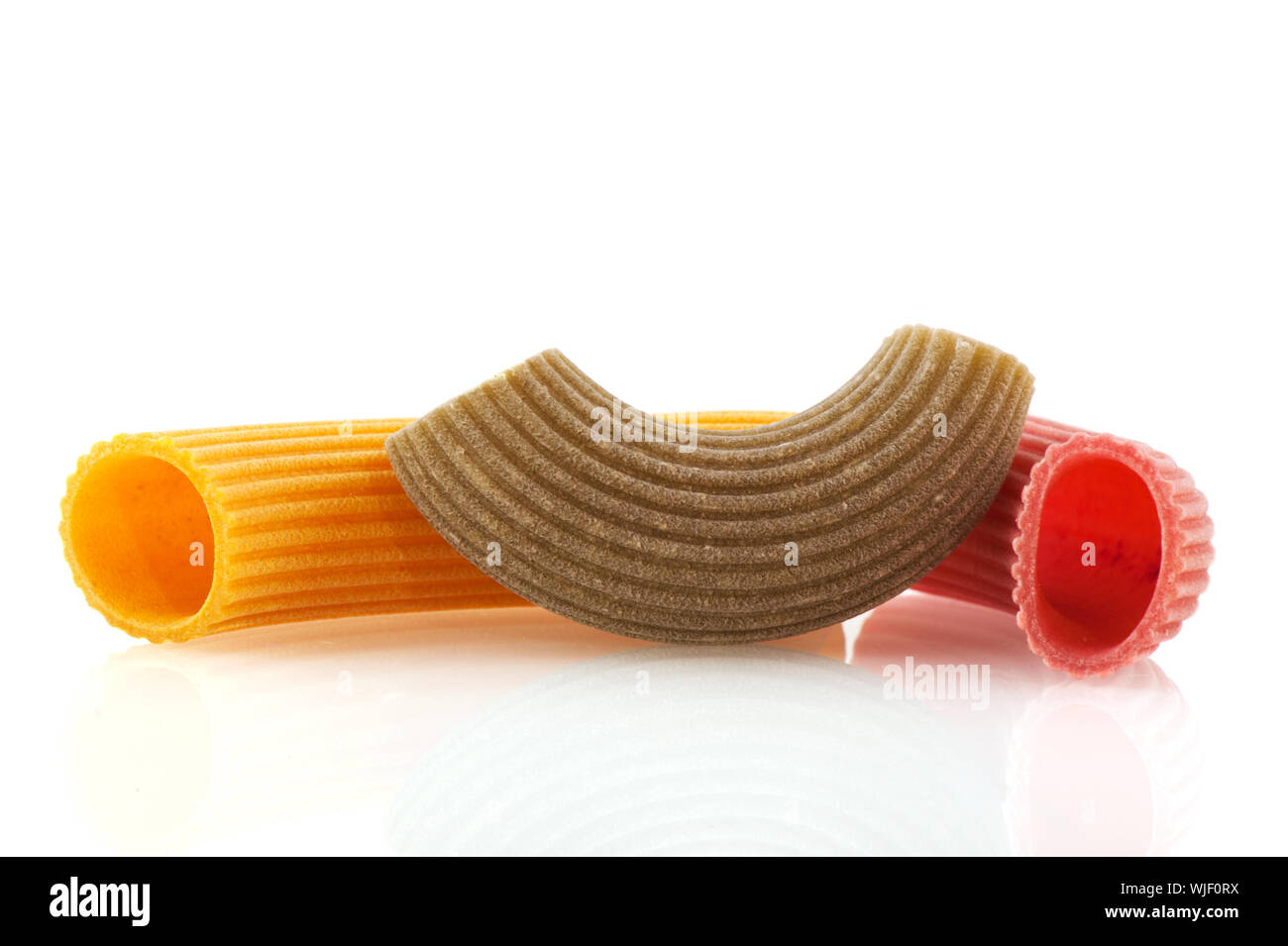 colorful raw pasta tubes in green red and white Stock Photo - Alamy