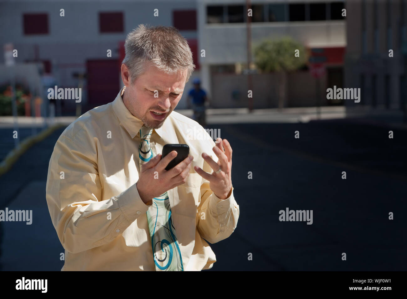 Man is frustrated with cell phone coverage Stock Photo - Alamy
