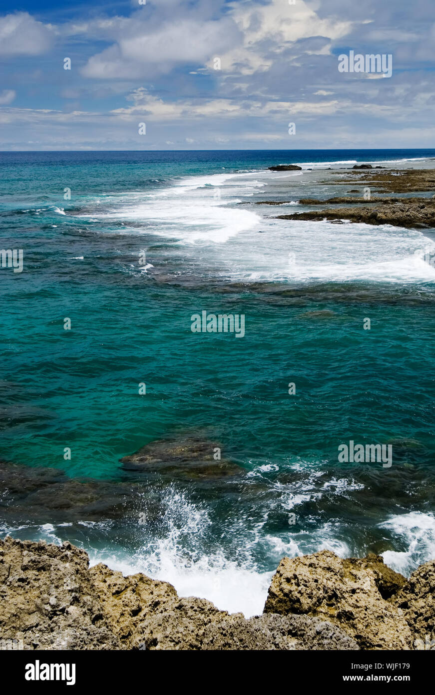 It is a beautiful coral reef rock cape with blue sky in kenting of ...