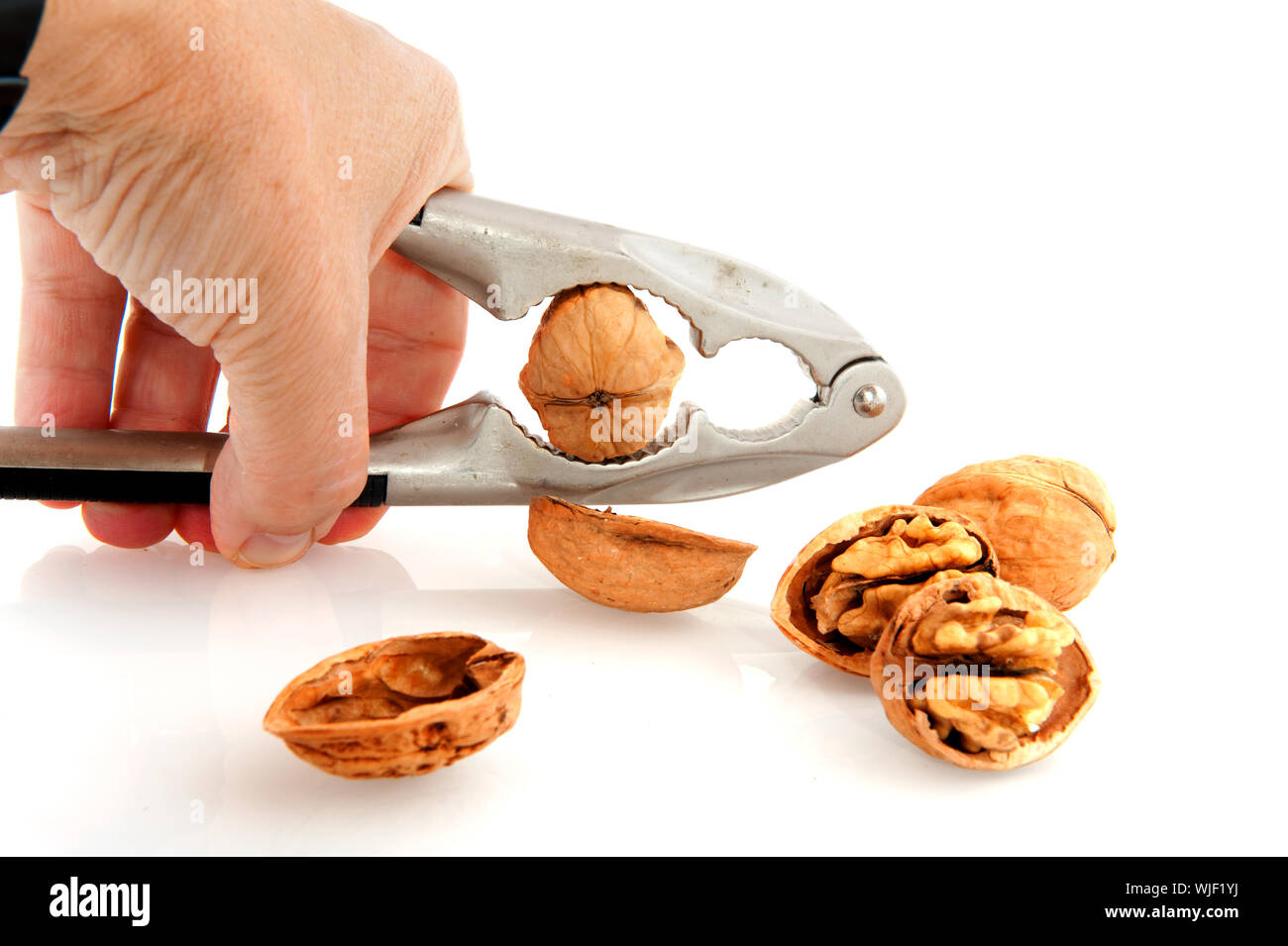 Hand cracking nuts hi-res stock photography and images - Alamy