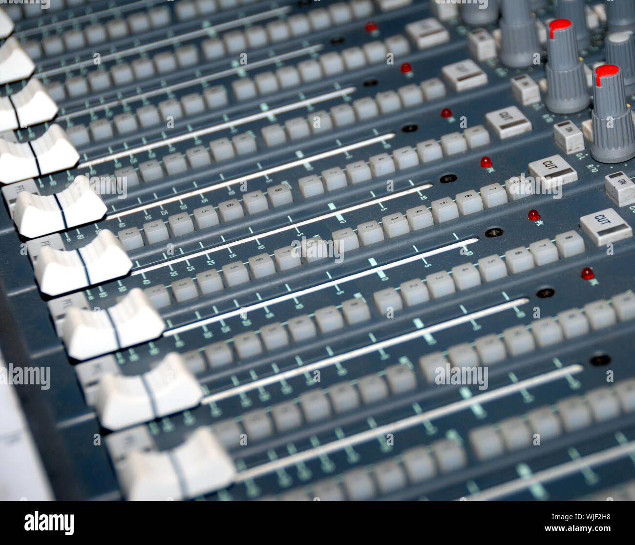 Audio mixing console in a recording studio. Faders and knobs of a sound ...