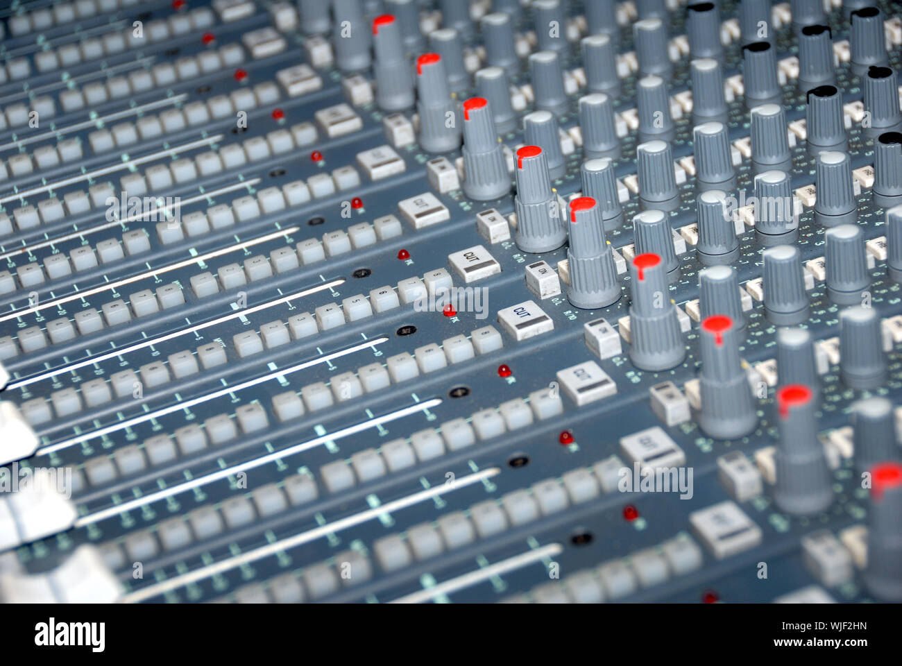 Audio mixing console in a recording studio. Faders and knobs of a sound ...