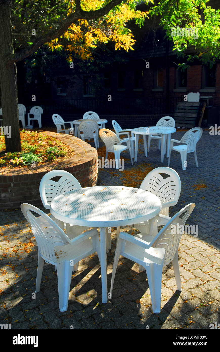 Empty tables of outdoor cafe in the fall Stock Photo - Alamy
