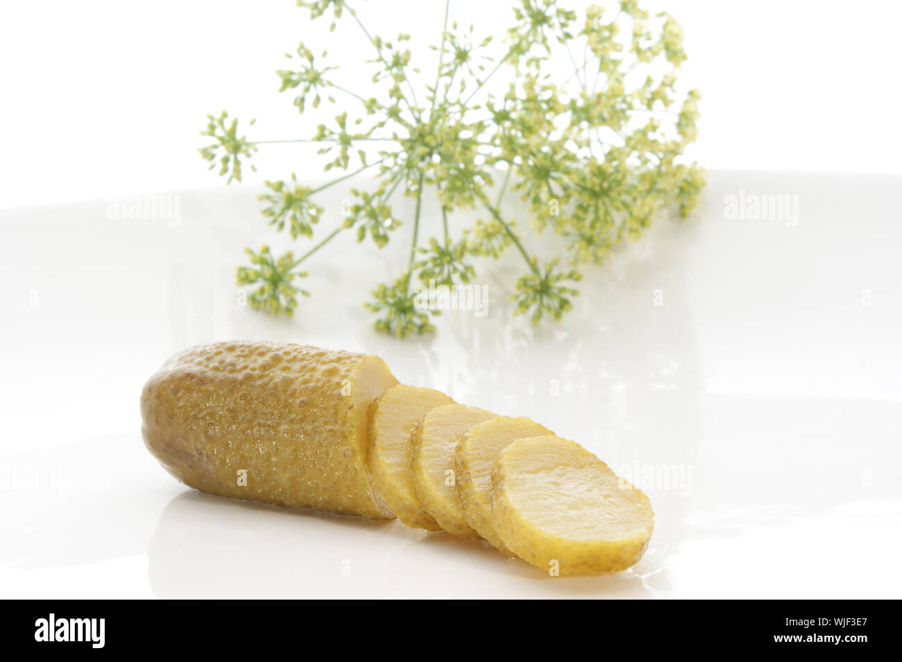 one sour gherkin cut half into slices Stock Photo - Alamy
