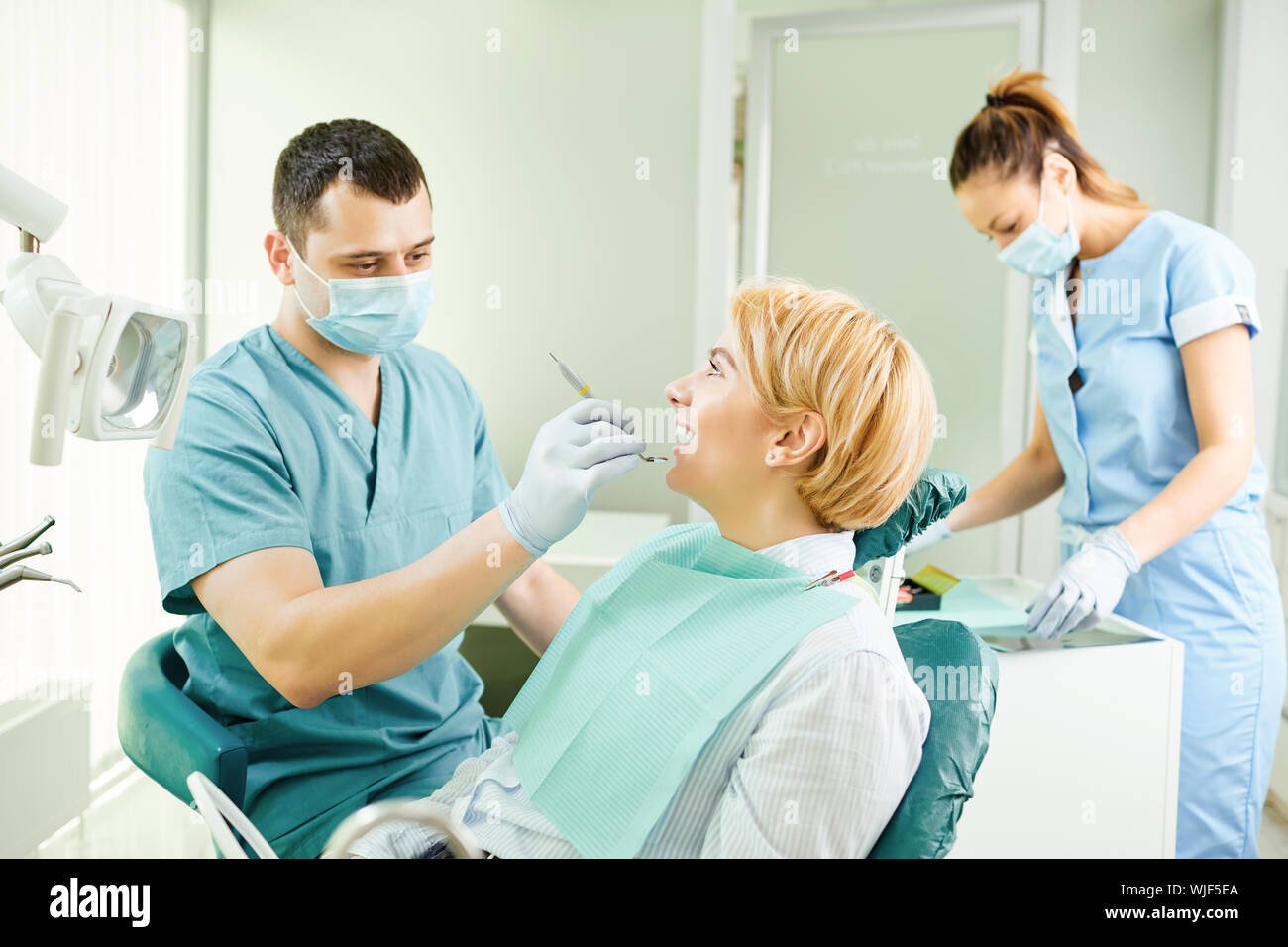 Dentist checks the teeth of the patient Stock Photo - Alamy