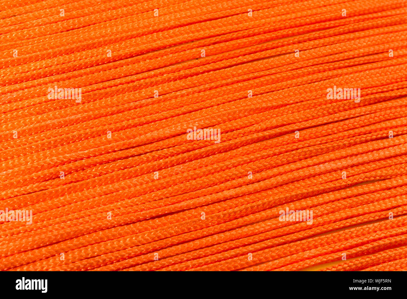 Macro close-up of braided orange polypropylene cord. Diam. approx. 2-3 ...