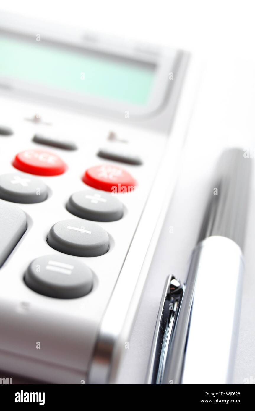 adding up figures concept with modern white calculator in office Stock ...