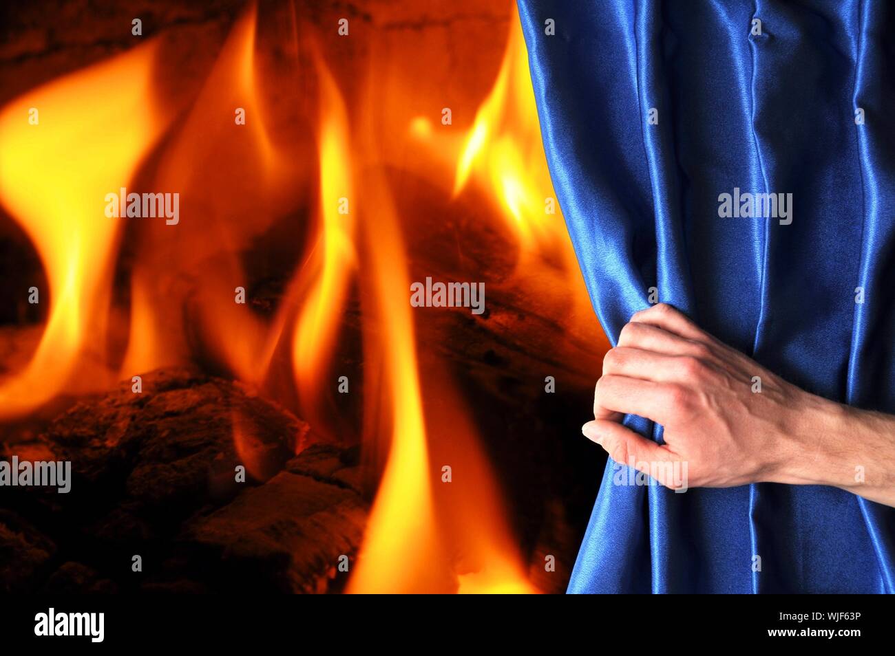 fire or flame hand and blue curtain with hand showing heat Stock Photo ...