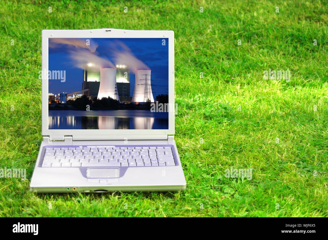 power plant in laptop or notebook screen showing energy supply concept ...