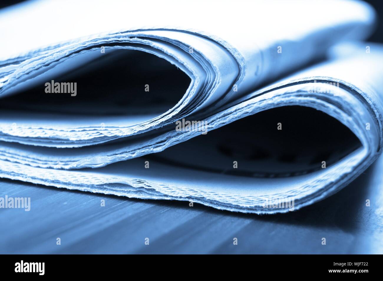 stack of newspaper on desktop showing news concept Stock Photo - Alamy