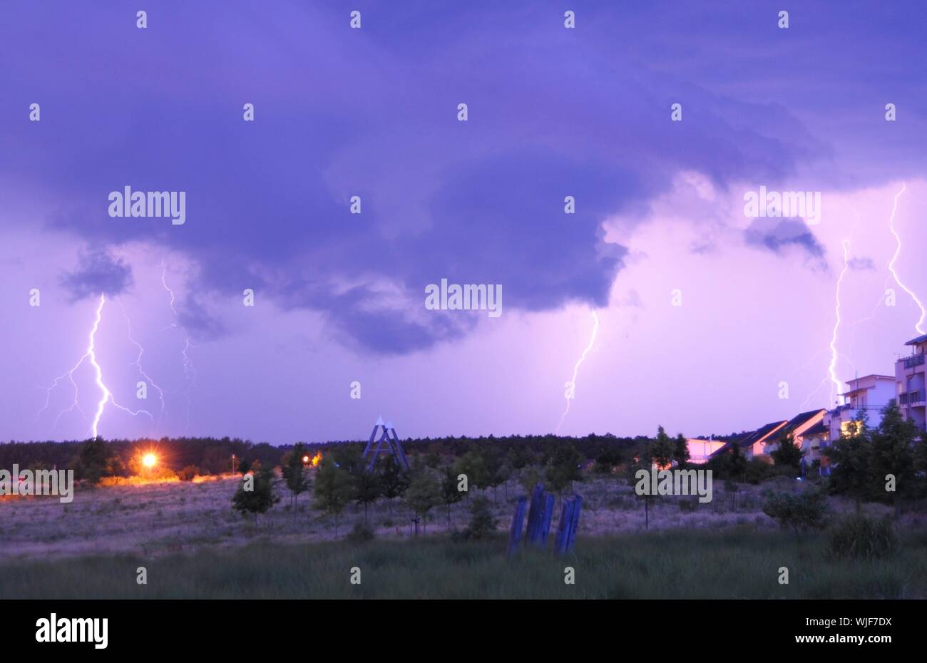 lightning on a thunderstorm in a park with cloudy sky Stock Photo - Alamy