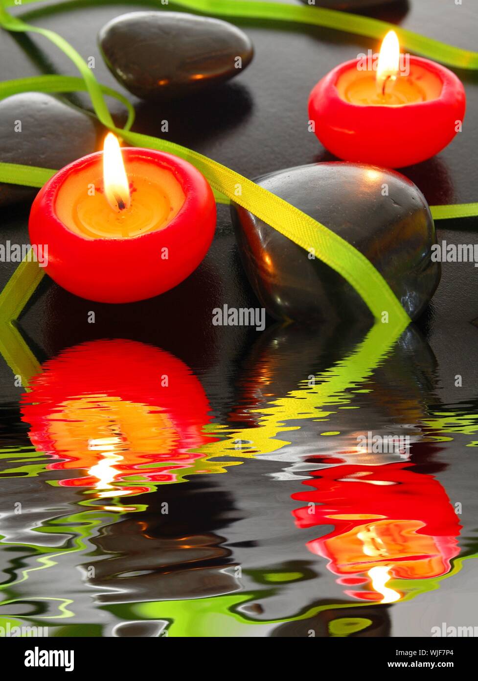 spa candle and water reflection showing zen concept Stock Photo - Alamy
