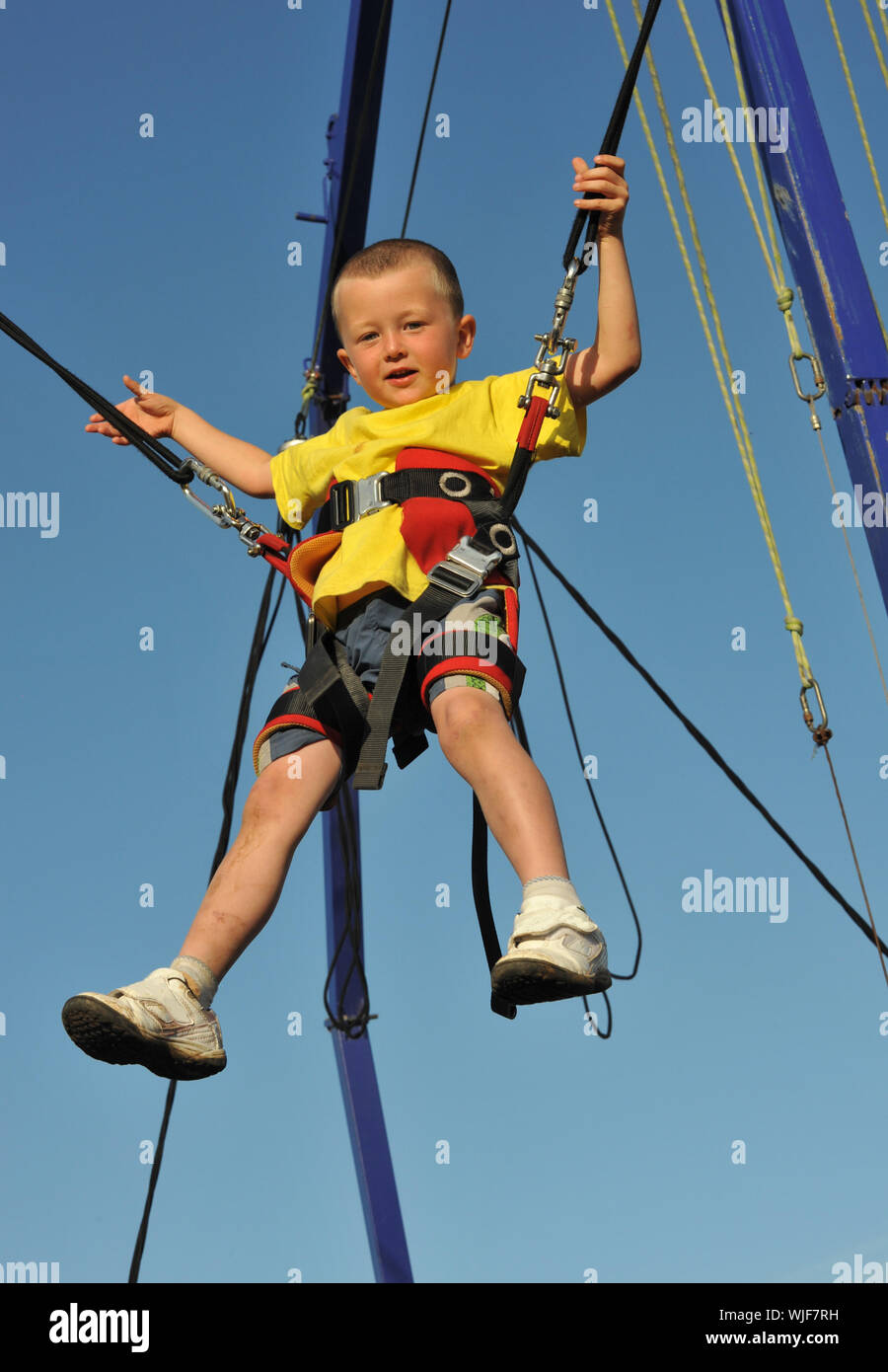 Little boy jumping on the trampoline (bungee jumping Stock Photo - Alamy