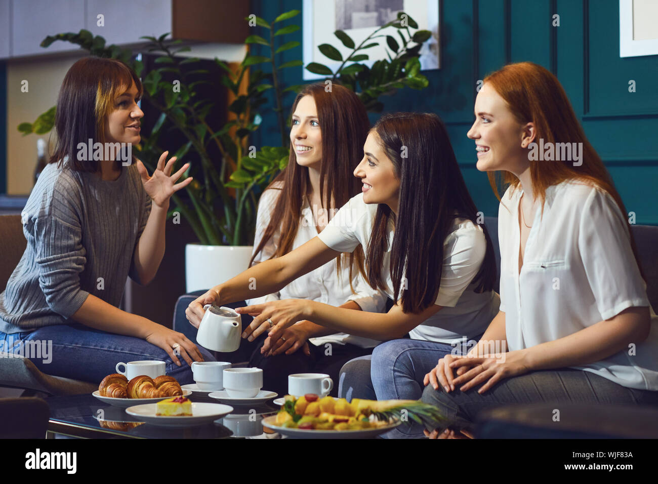 Young women having tea party at home Stock Photo - Alamy