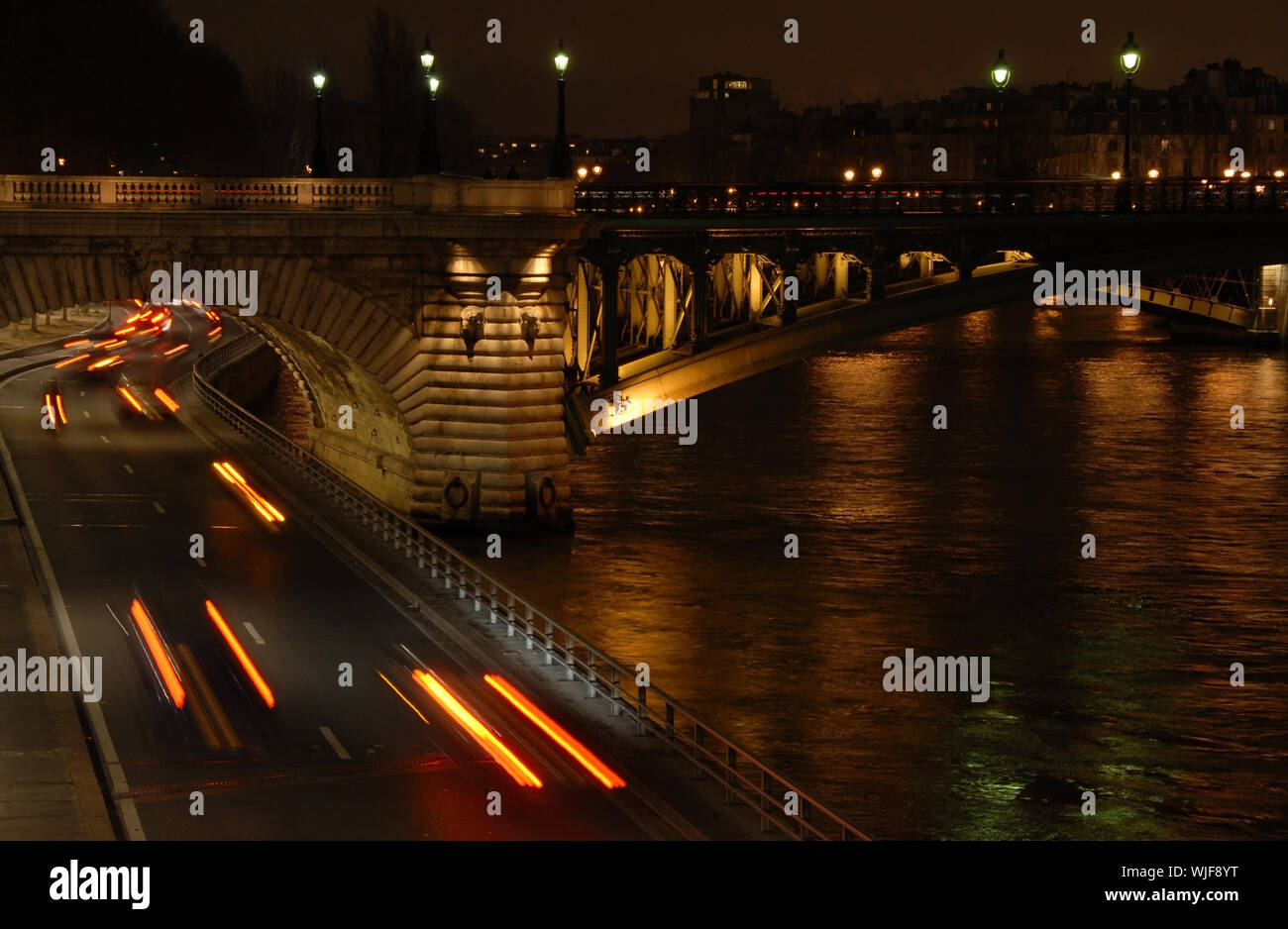 Traffic on a highway at night under a bridge in Paris (France Stock ...