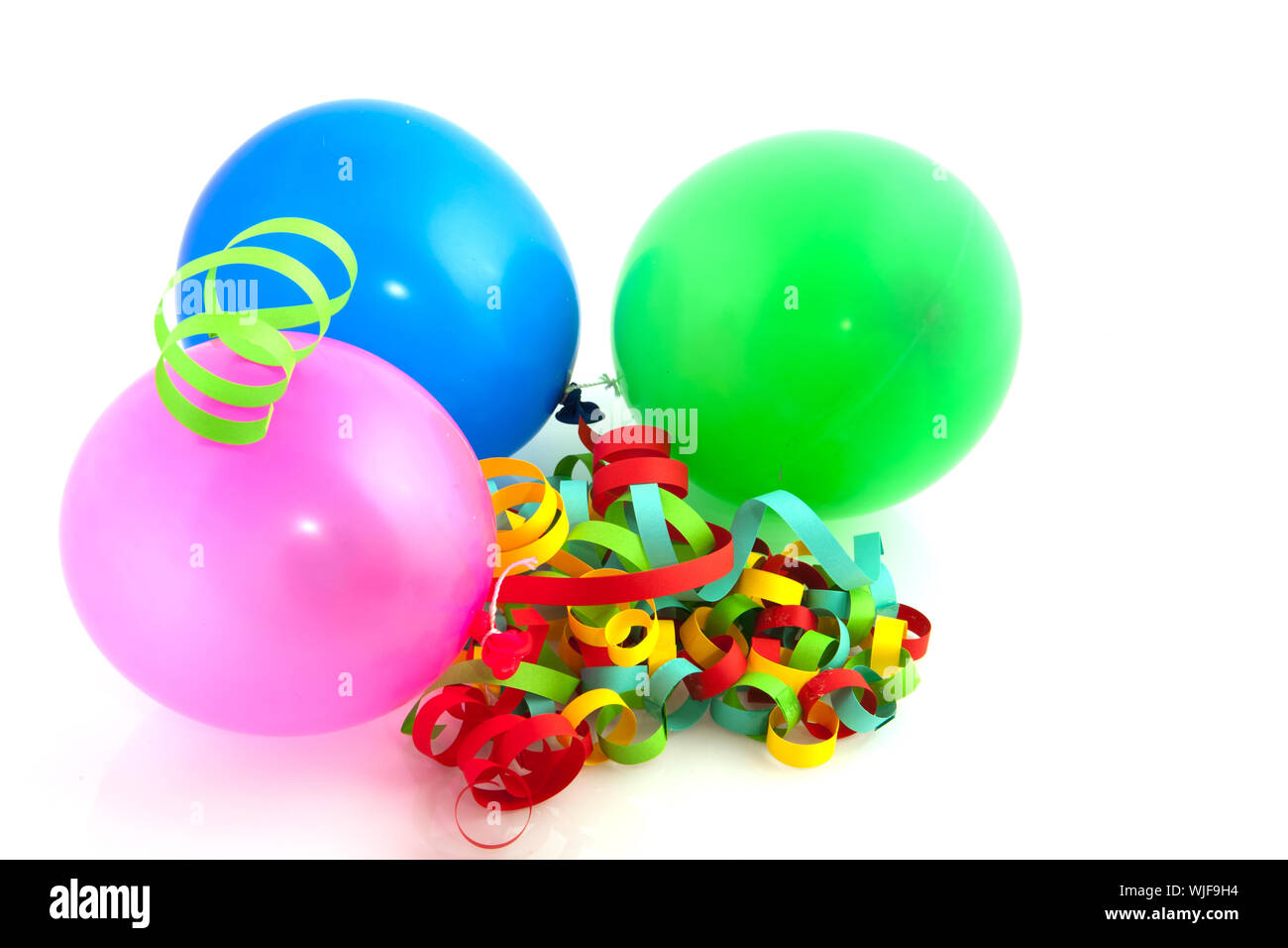 colorful balloons and paper chains streamers isolated over white Stock ...