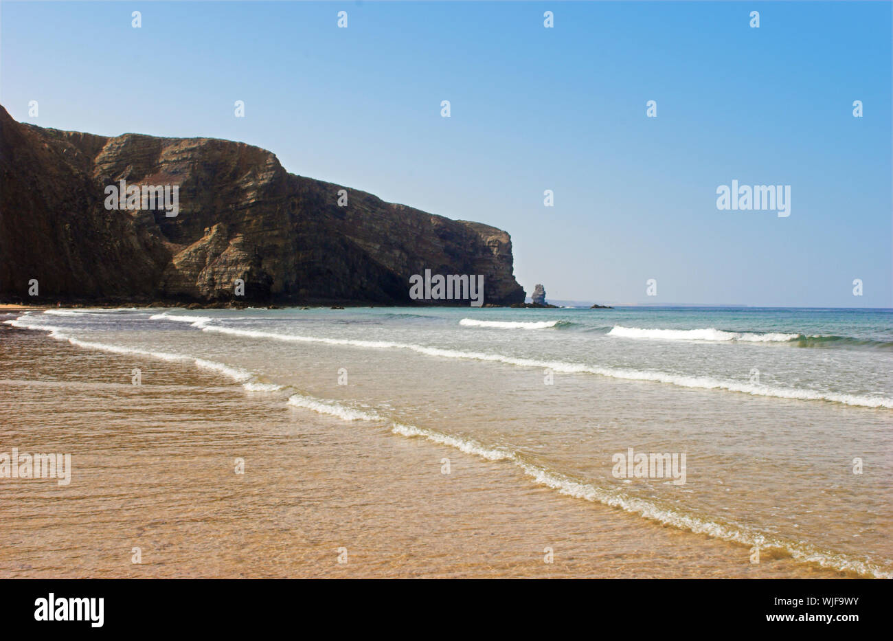 Beautiful blue beach with rocks and turquoise water Stock Photo - Alamy