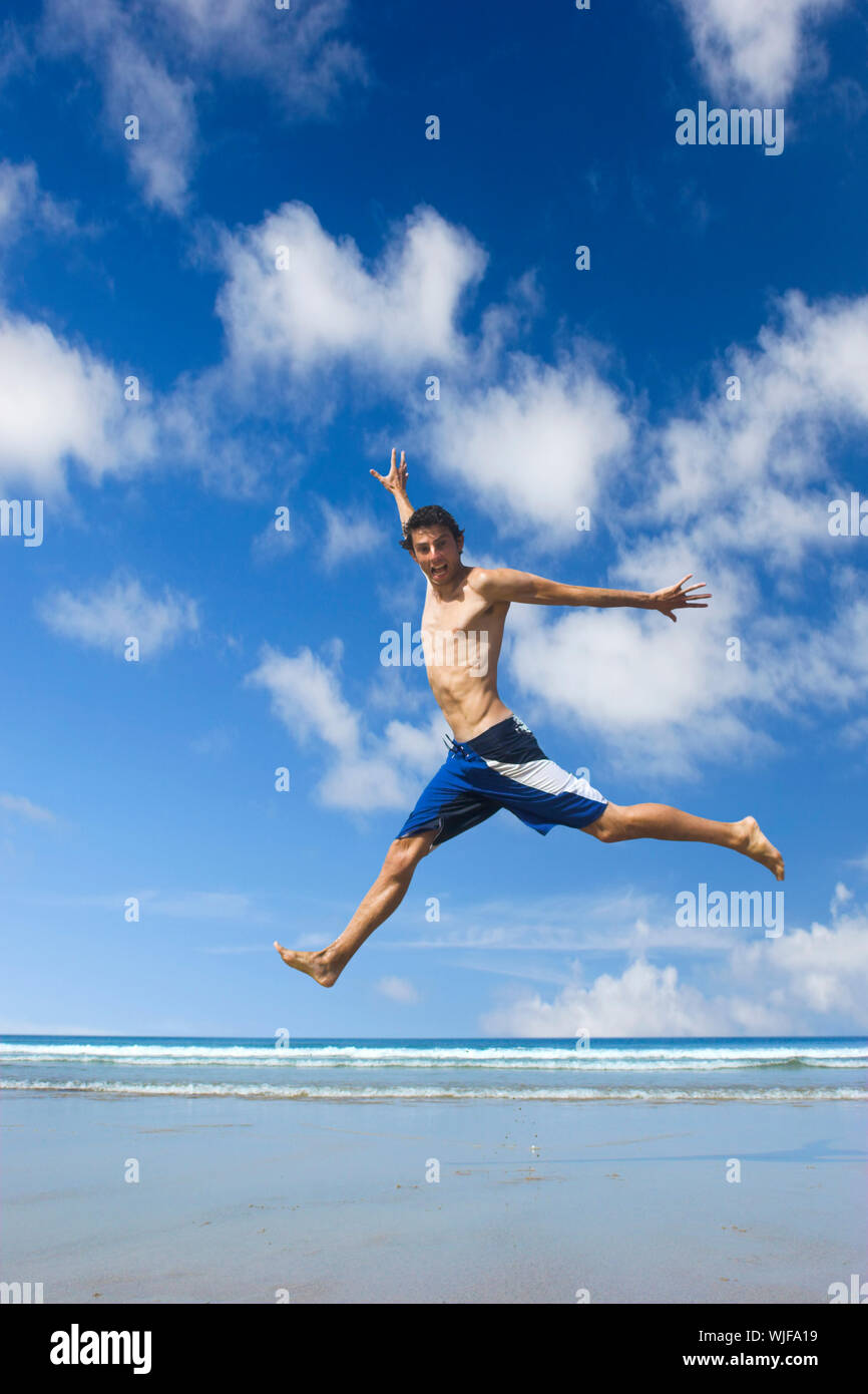 Picture of a young man jumping on the beach Stock Photo - Alamy