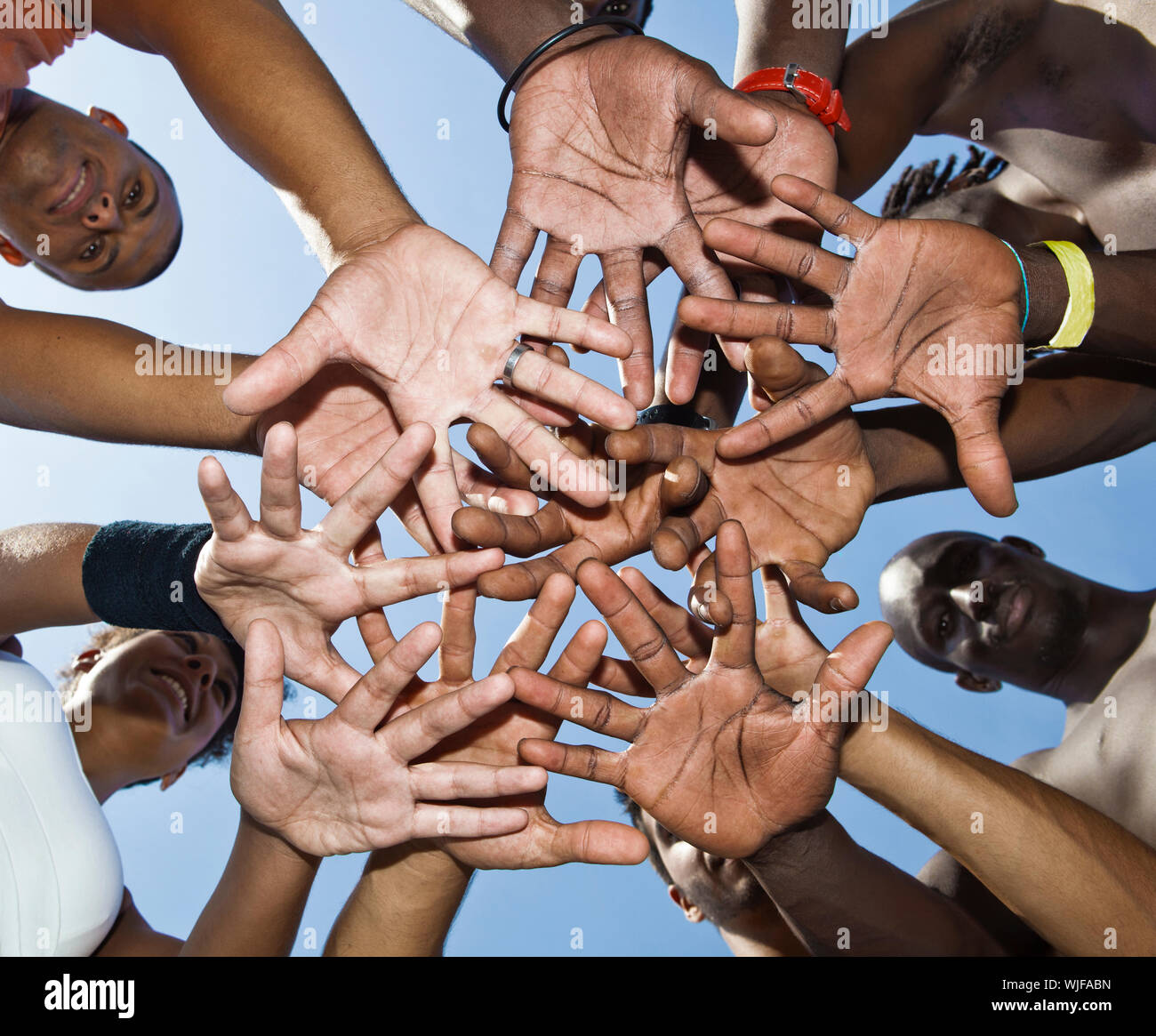 A group of mixed race people putting hands together Stock Photo - Alamy