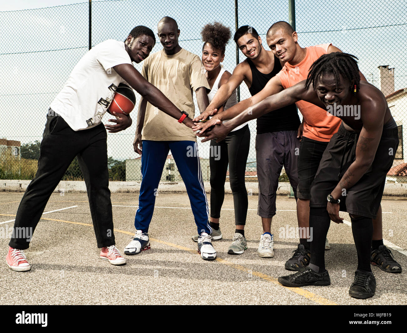 A group of mixed race people putting hands together Stock Photo - Alamy