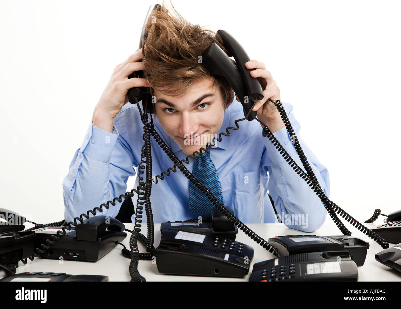 Answering several phones at work hi-res stock photography and images ...