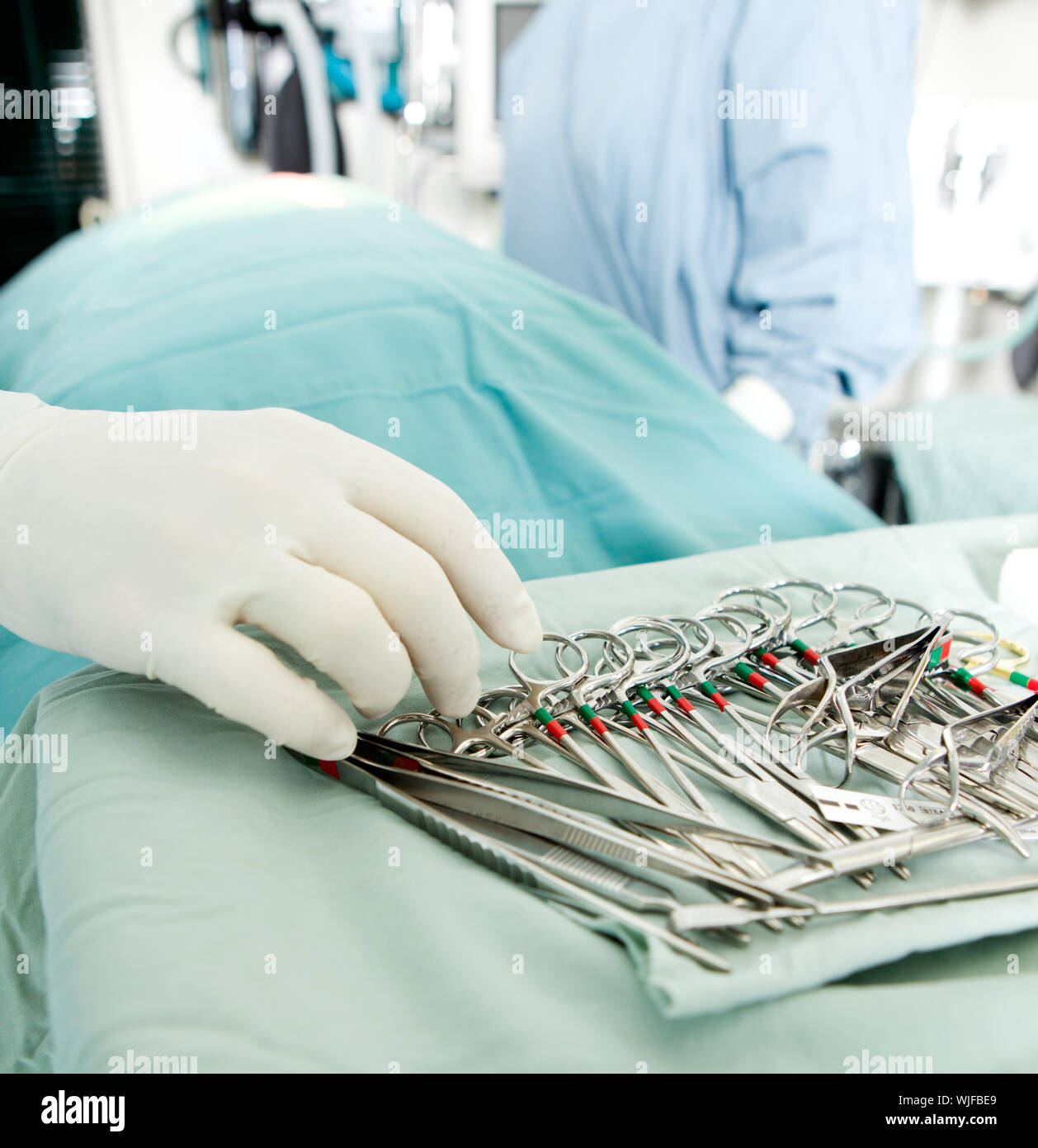 Detail shot of steralized surgery instruments with a hand grabbing a ...
