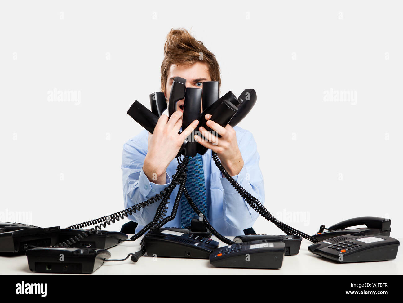 Answering several phones at work hi-res stock photography and images ...