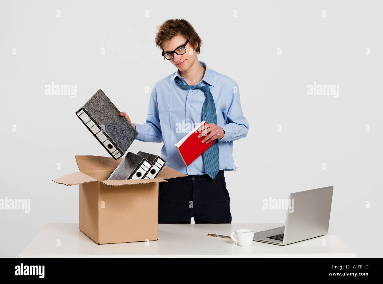 Businessman packing up box in office hi-res stock photography and ...