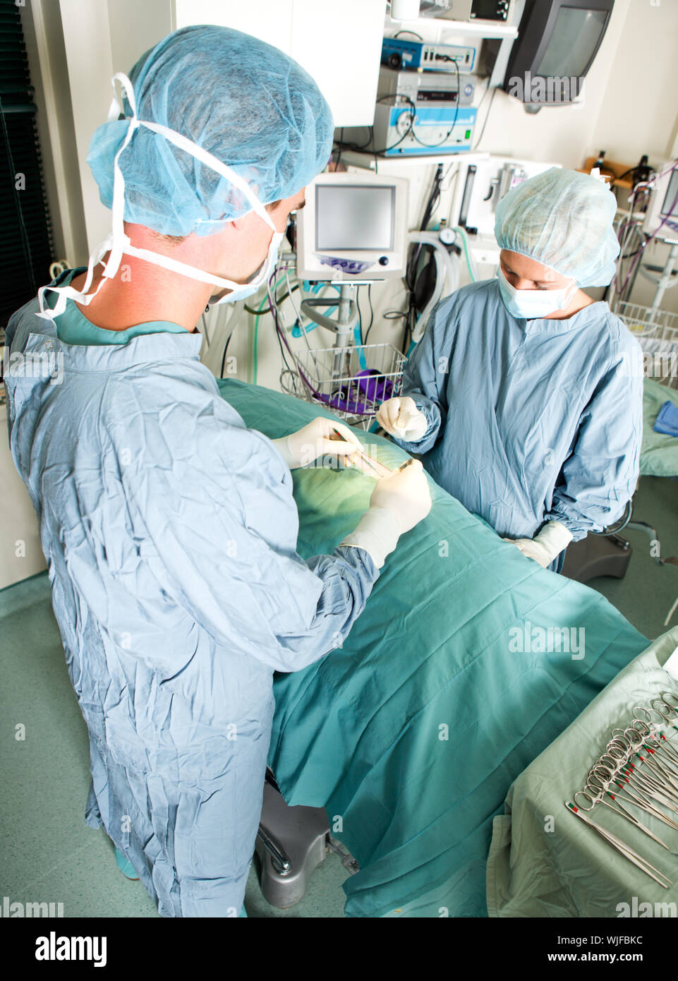 A team doing surgery in a small operating room Stock Photo - Alamy