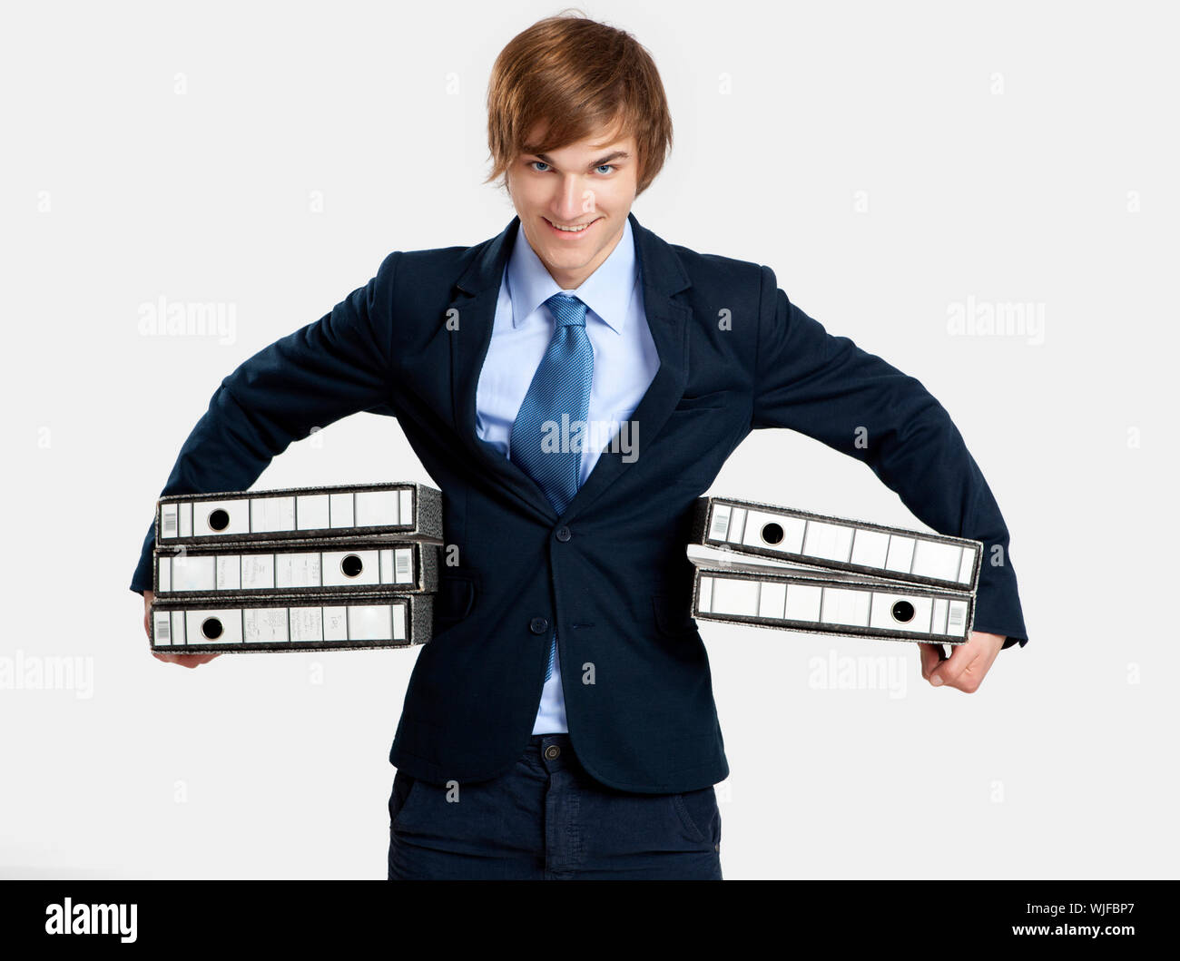 Young business man carrying a bunch of folders Stock Photo - Alamy
