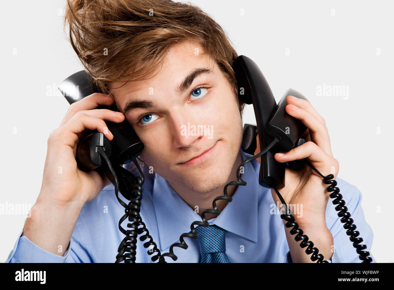 Answering several phones at work hi-res stock photography and images ...