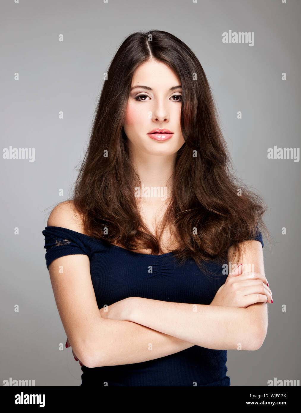 Studio portrait of a beautiful young woman with hands folded Stock ...
